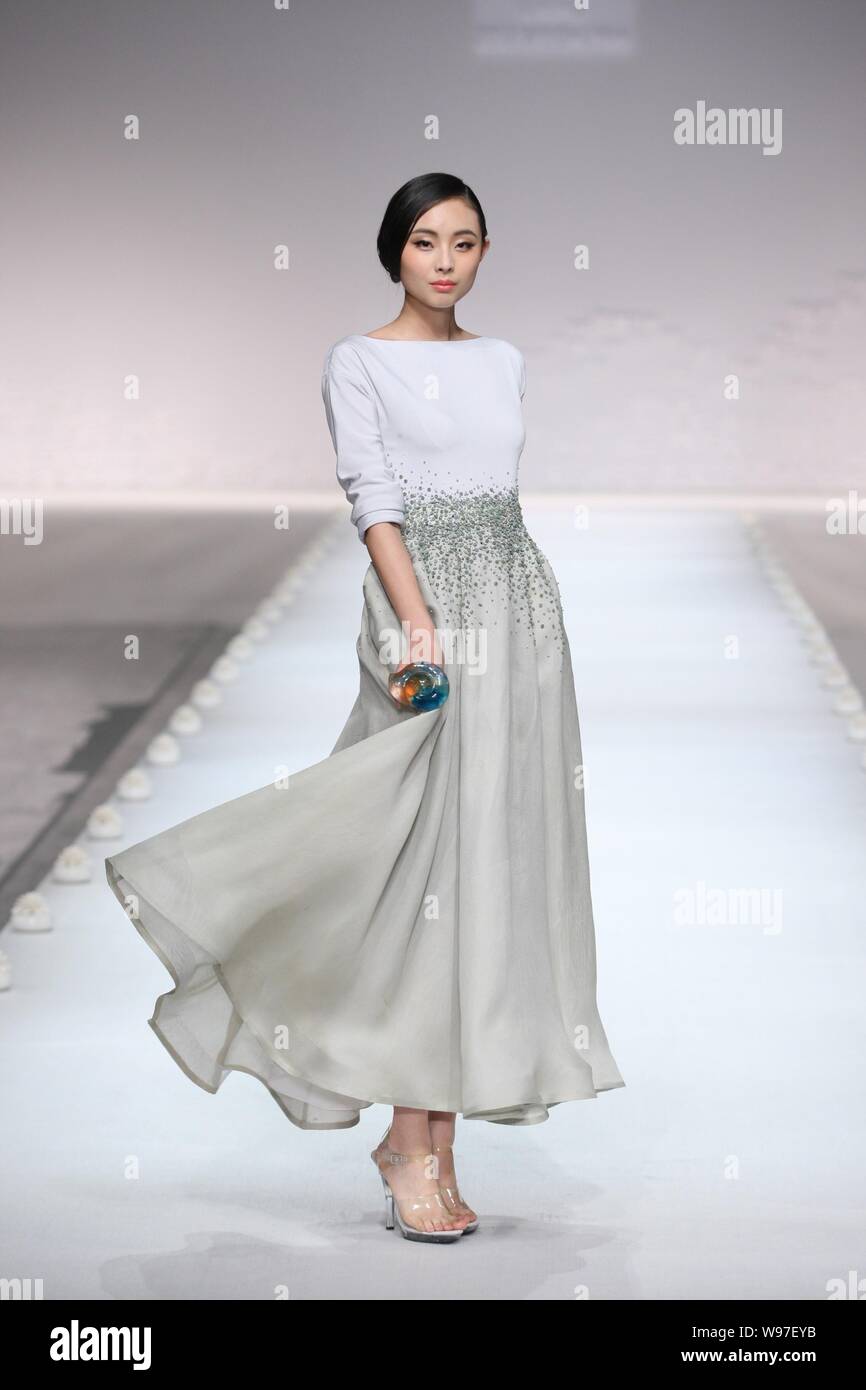 A model displays a new creation by designer Chu Yan in her fashion show ...