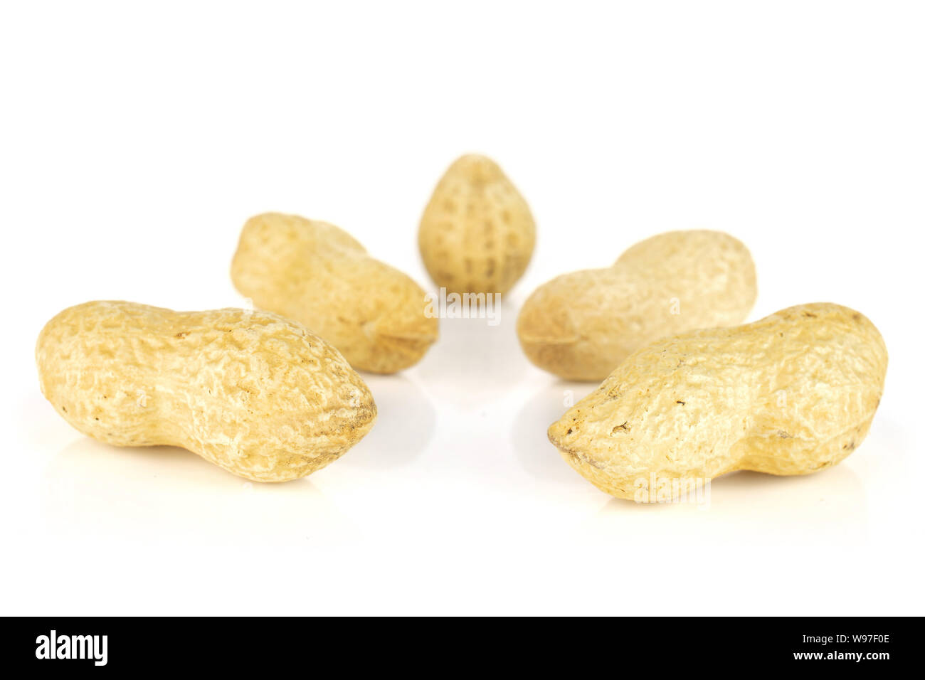 Group of five whole natural yellow peanut arranged symmetrically ...
