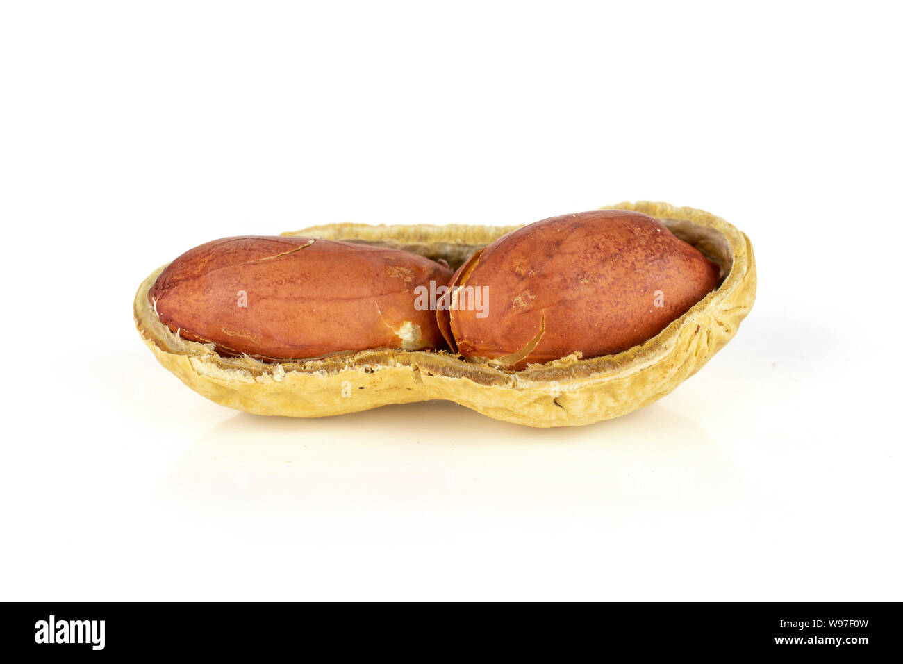 Group of two whole one piece of natural yellow peanut in closeup ...