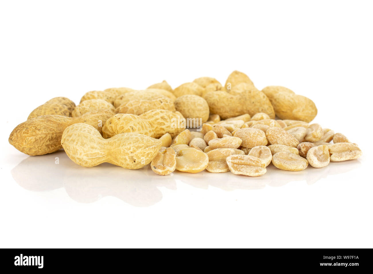 Lot of whole lot of halves of natural yellow peanut isolated on white ...