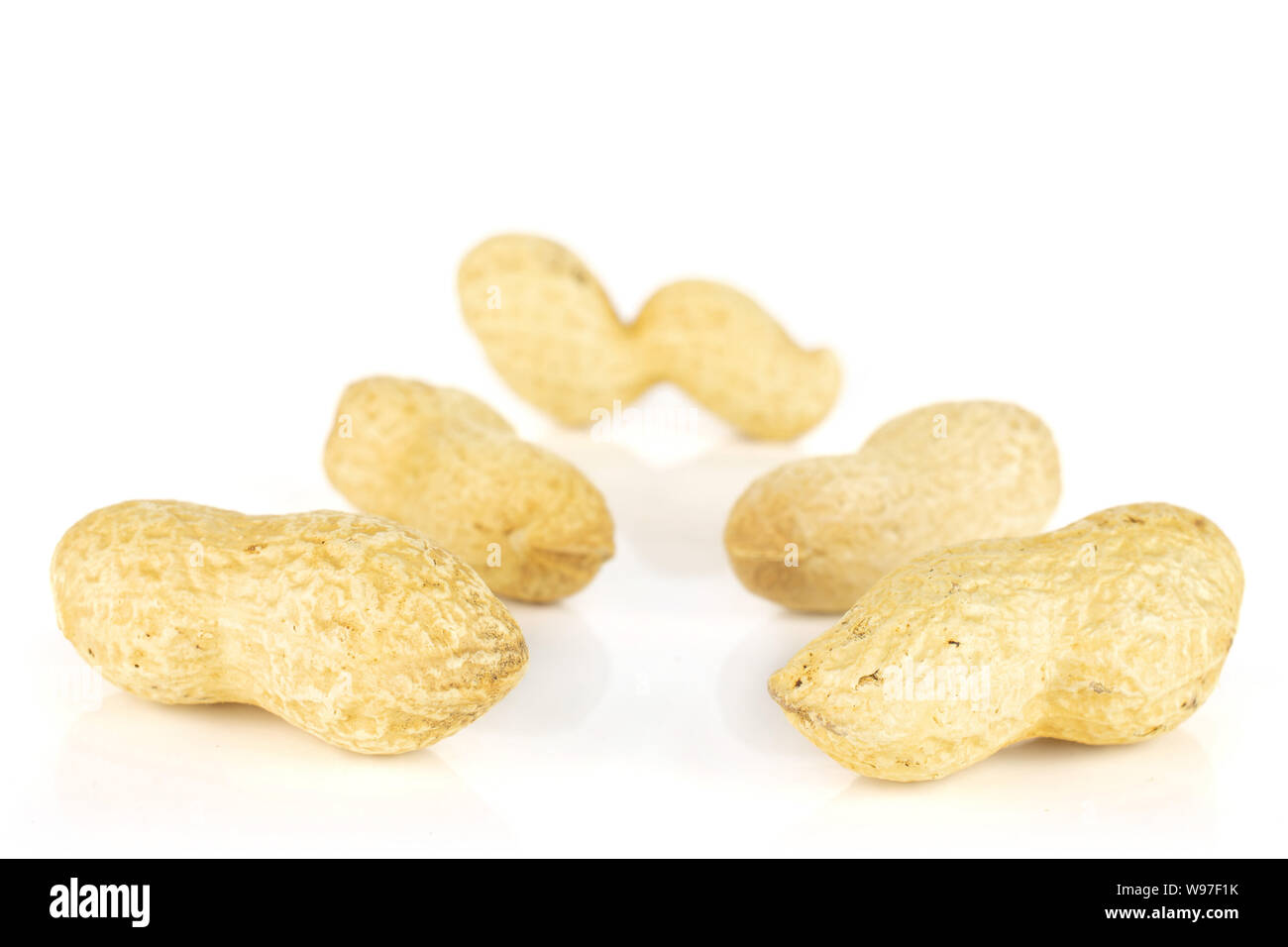 Group of five whole natural yellow peanut arranged symmetrically ...