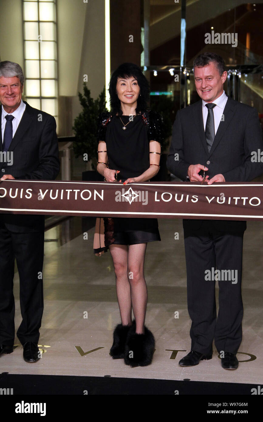 Hong Kong actress Maggie Cheung, center, Yves Carcelle, left, Chairman ...