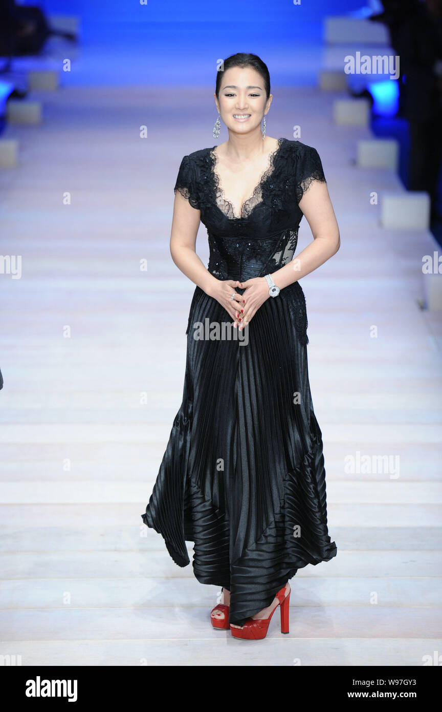 Chinese actress Gong Li poses at the Aimer 2012 swimwear fashion show ...
