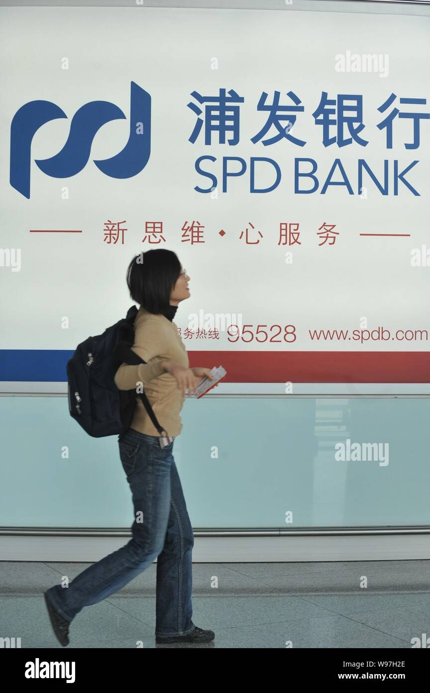 --File--A pedestrian walks past an advertisement for Shanghai Pudong ...