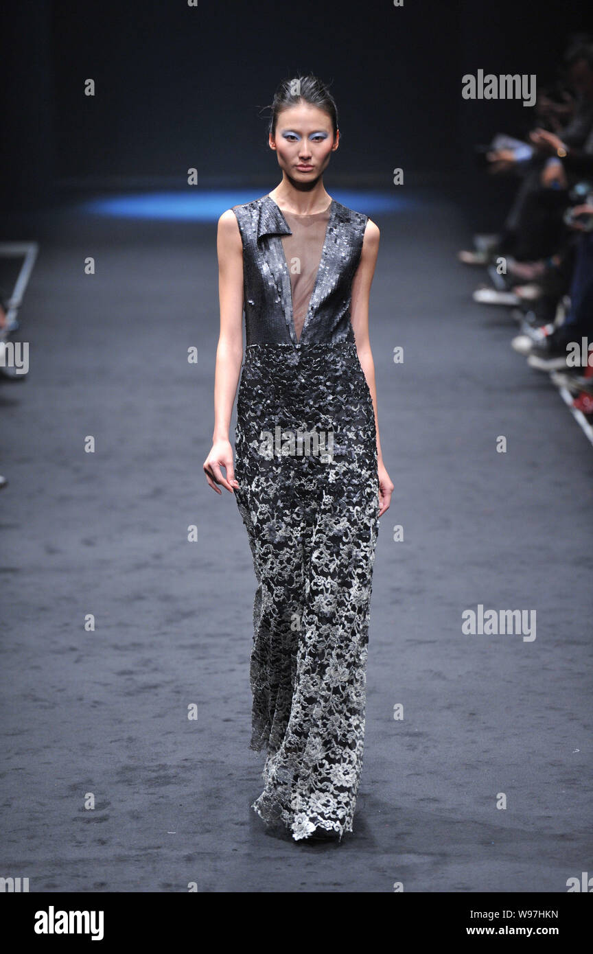 A model displays a new creation by designer Wang Peiyi in his fashion ...