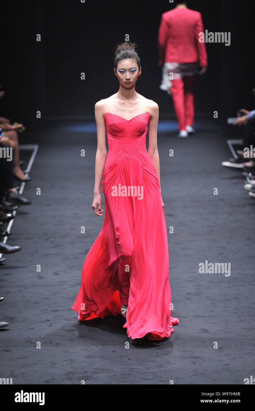 A model displays a new creation by designer Wang Peiyi in his fashion ...