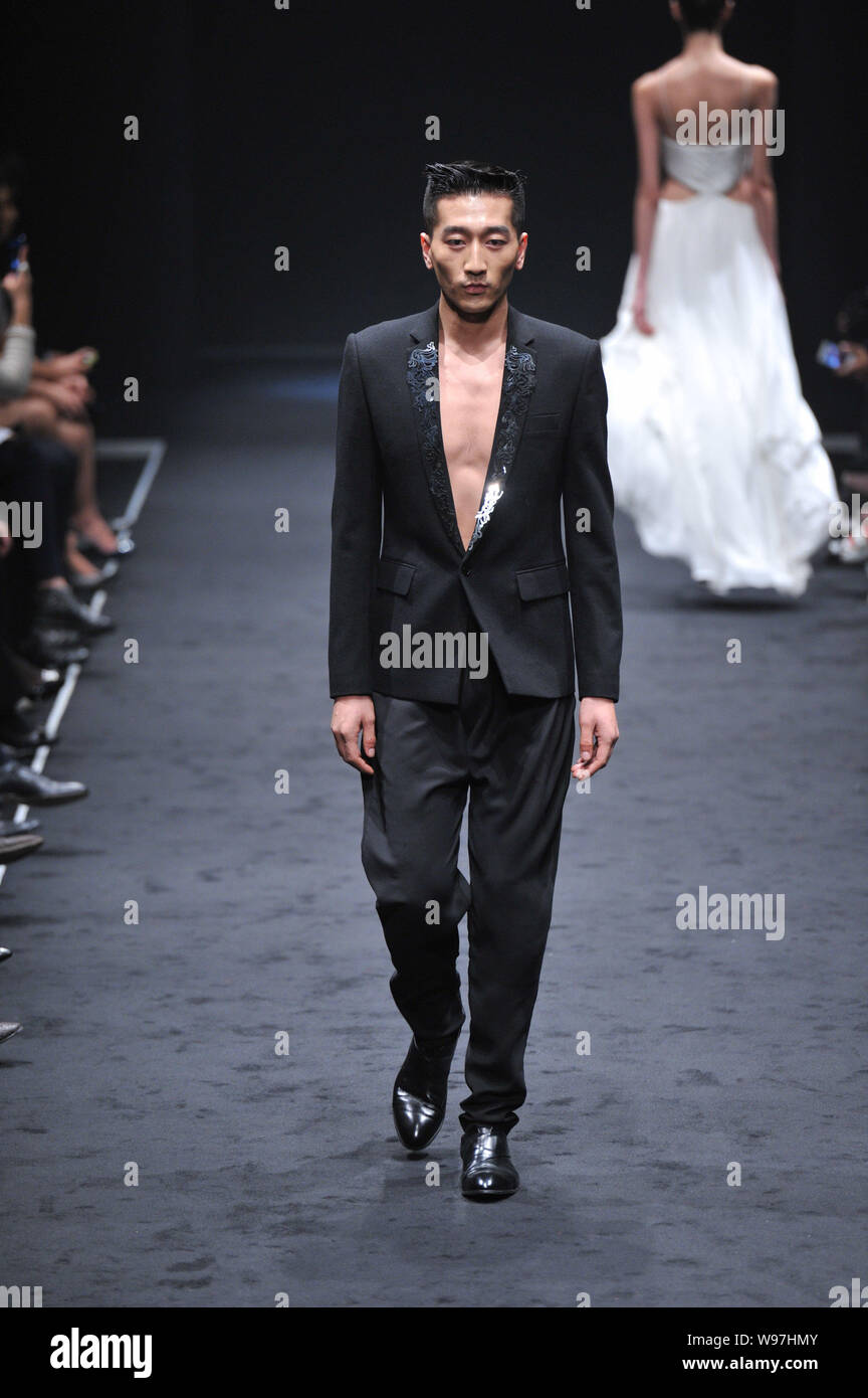 A model displays a new creation by designer Wang Peiyi in his fashion ...