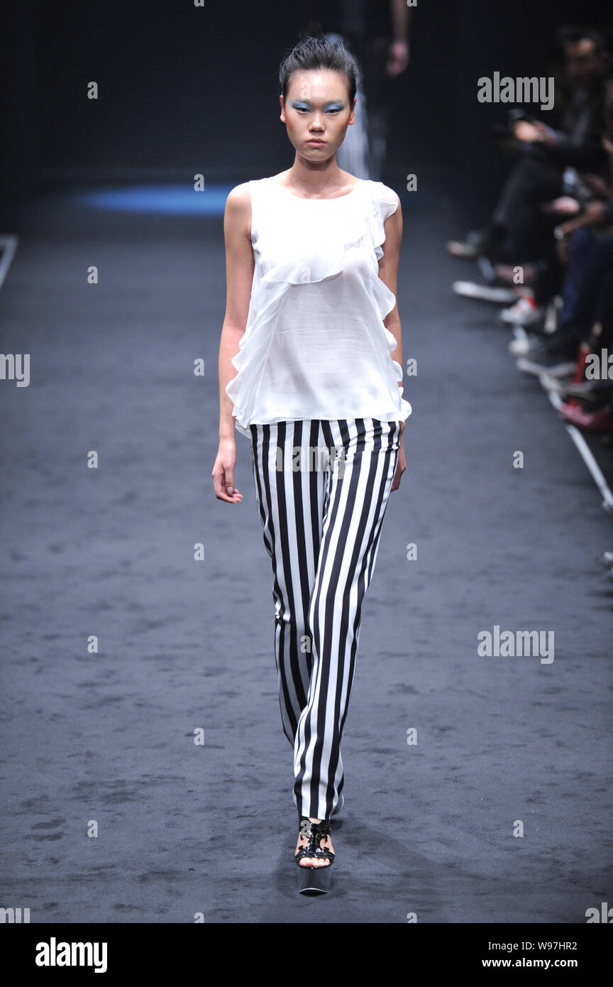 A model displays a new creation by designer Wang Peiyi in his fashion ...