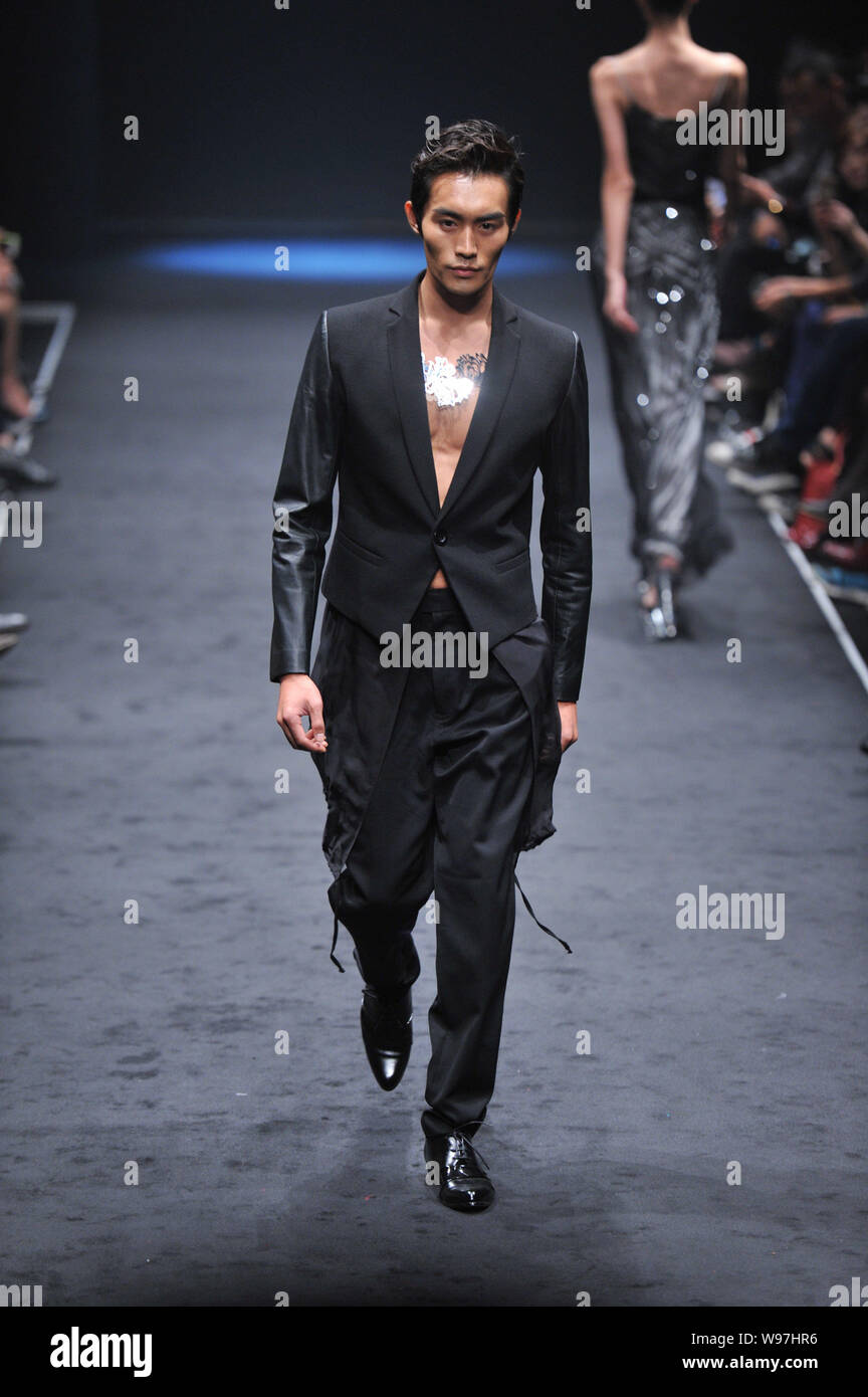 A model displays a new creation by designer Wang Peiyi in his fashion ...