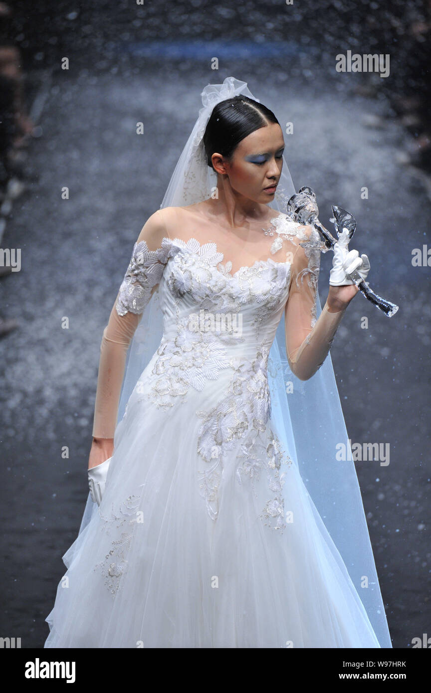 A model displays a new creation by designer Wang Peiyi in his fashion ...