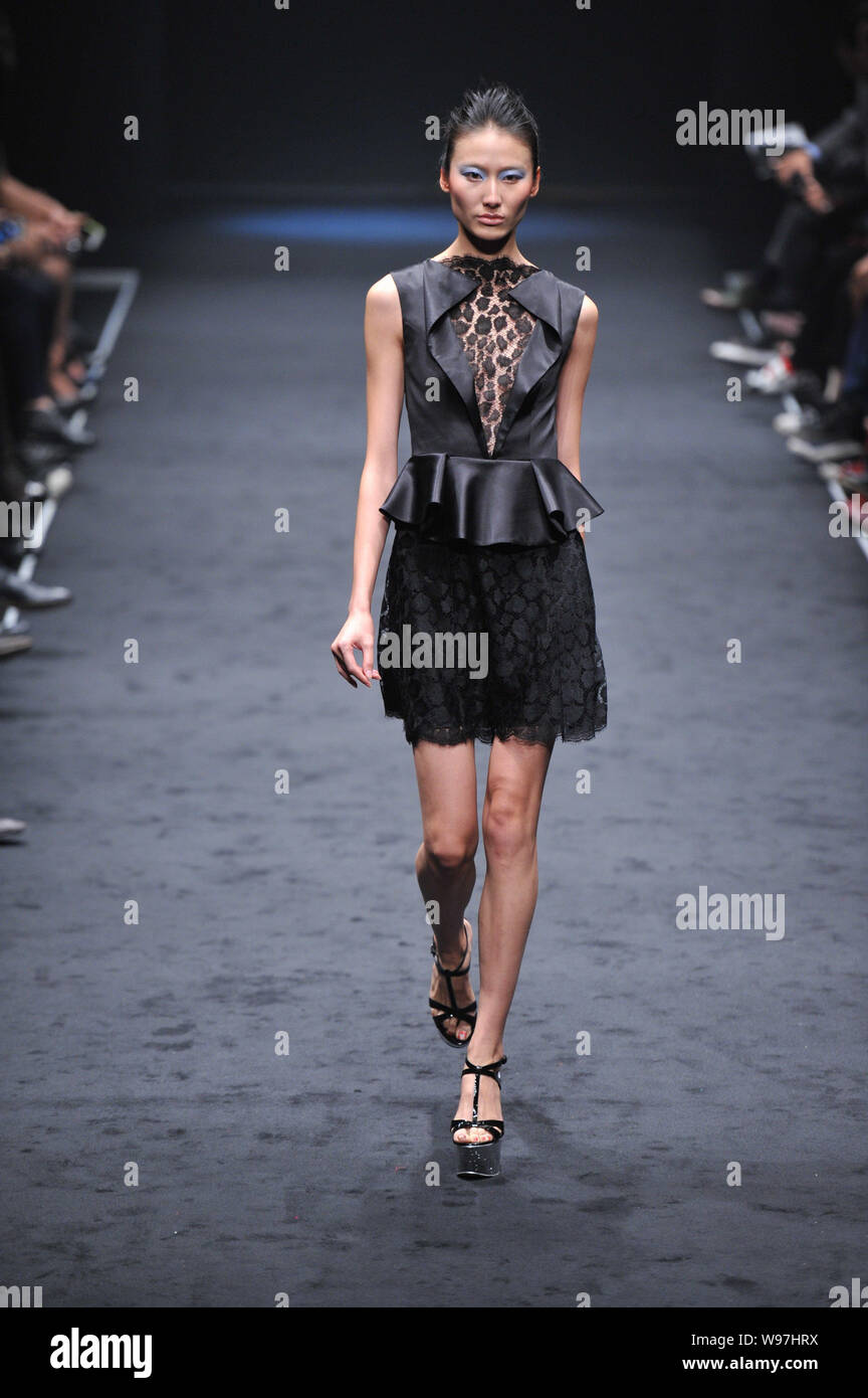 A model displays a new creation by designer Wang Peiyi in his fashion ...