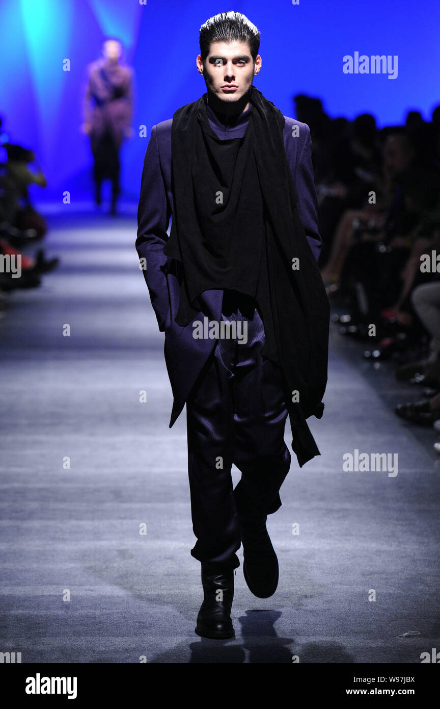 A model presents the new creation by Chinese fashion designer Simon Gao during his 2012 Autumn ...