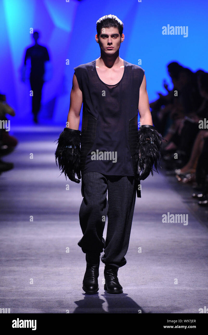 A model presents the new creation by Chinese fashion designer Simon Gao during his 2012 Autumn ...