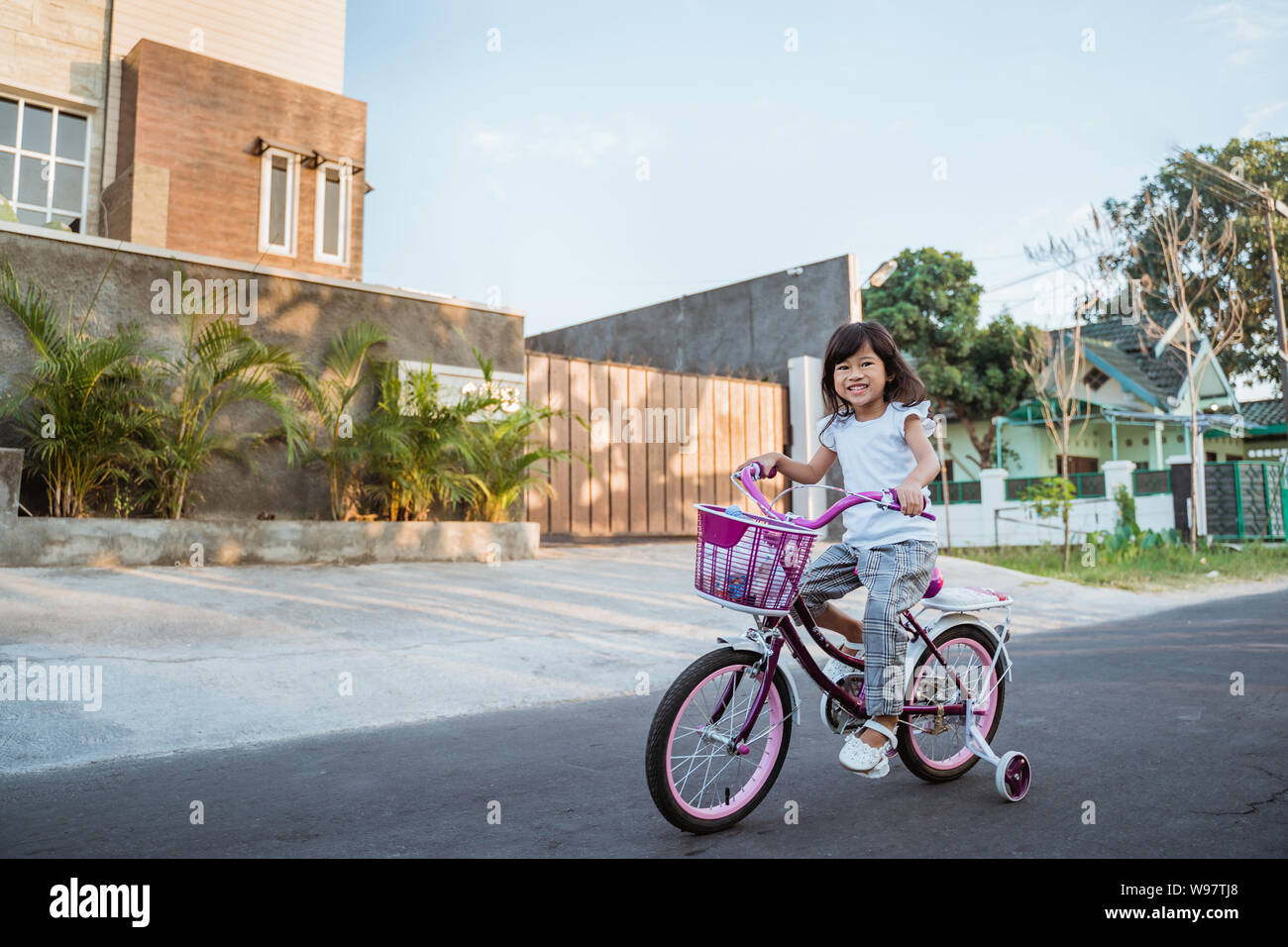 kid enjoy riding her bicycle outdoor Stock Photo - Alamy
