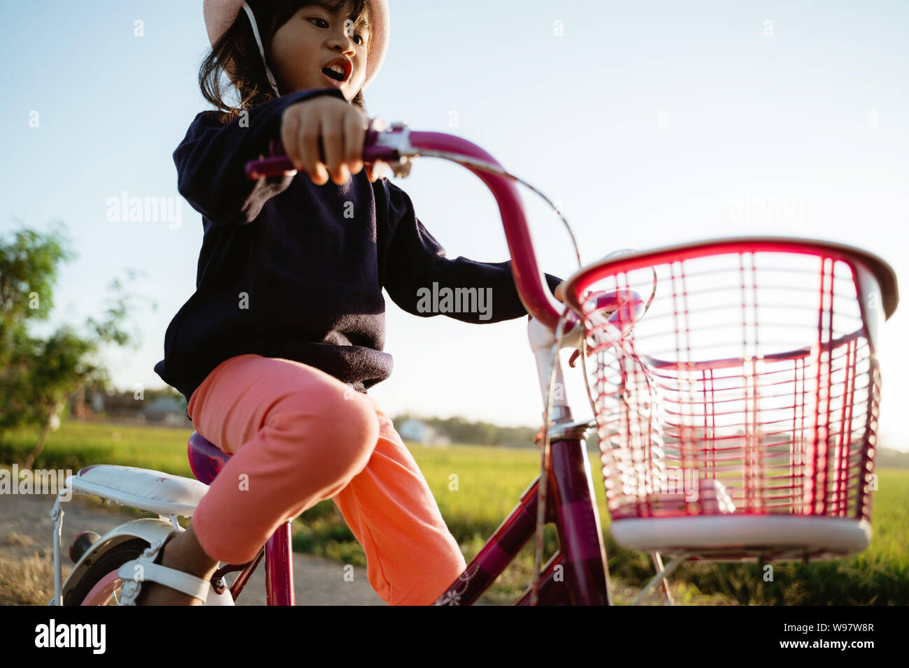 independent asian child ride her bicycle Stock Photo - Alamy