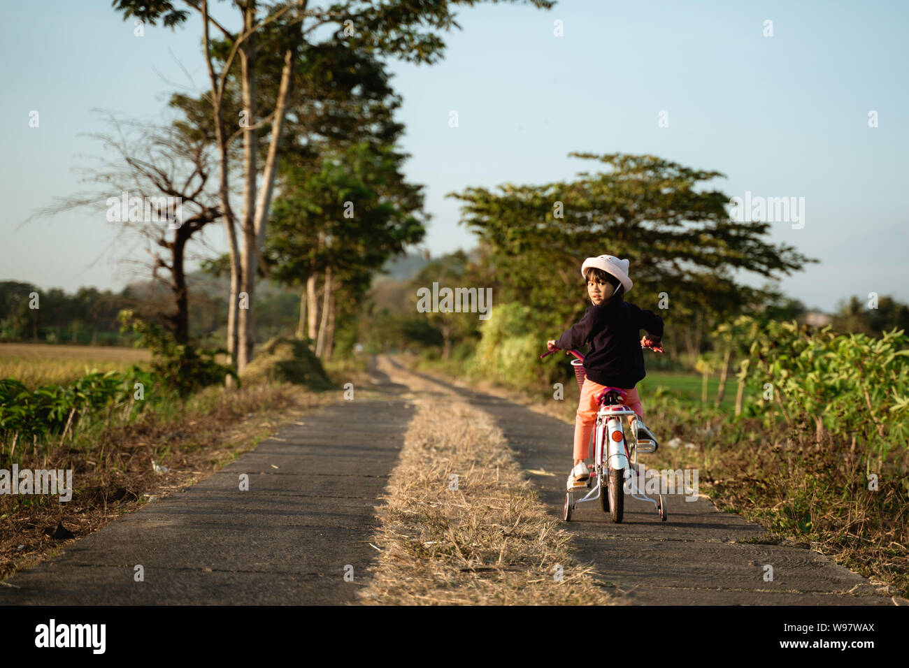 independent asian child ride her bicycle Stock Photo - Alamy