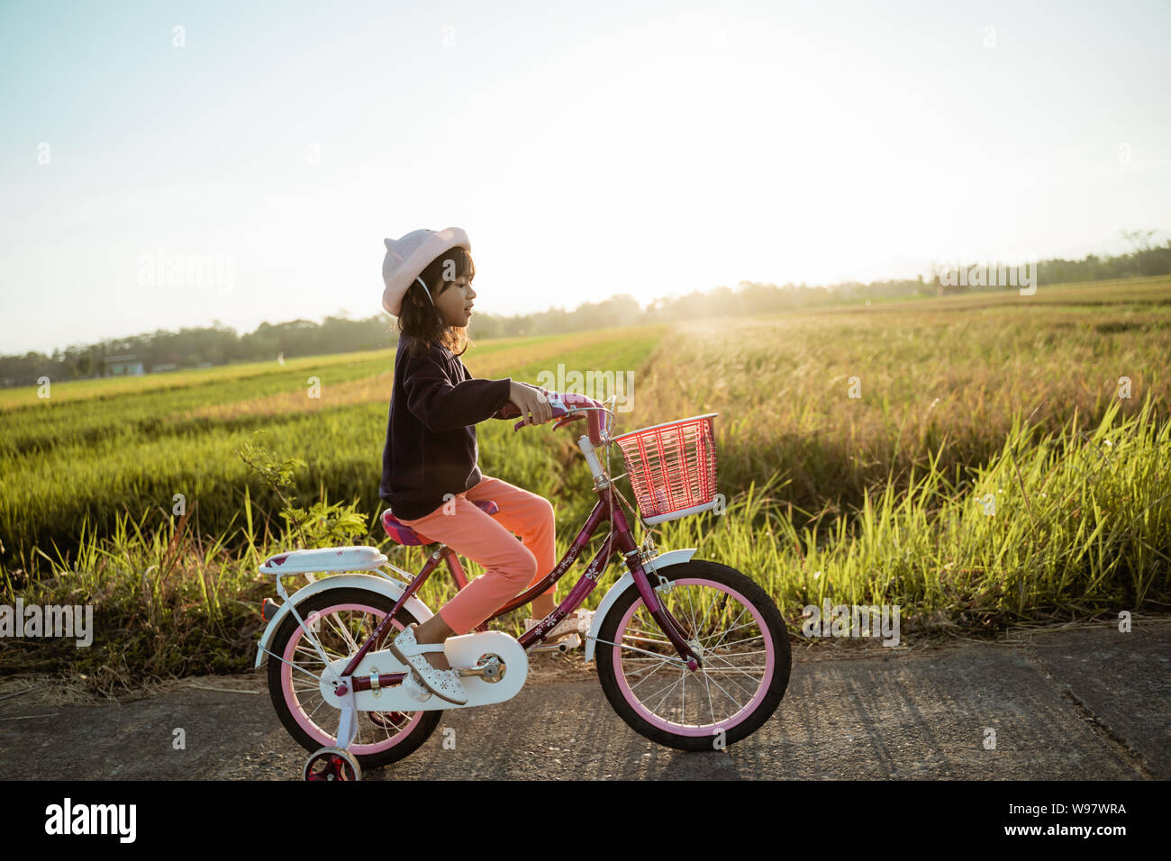 independent asian child ride her bicycle Stock Photo - Alamy