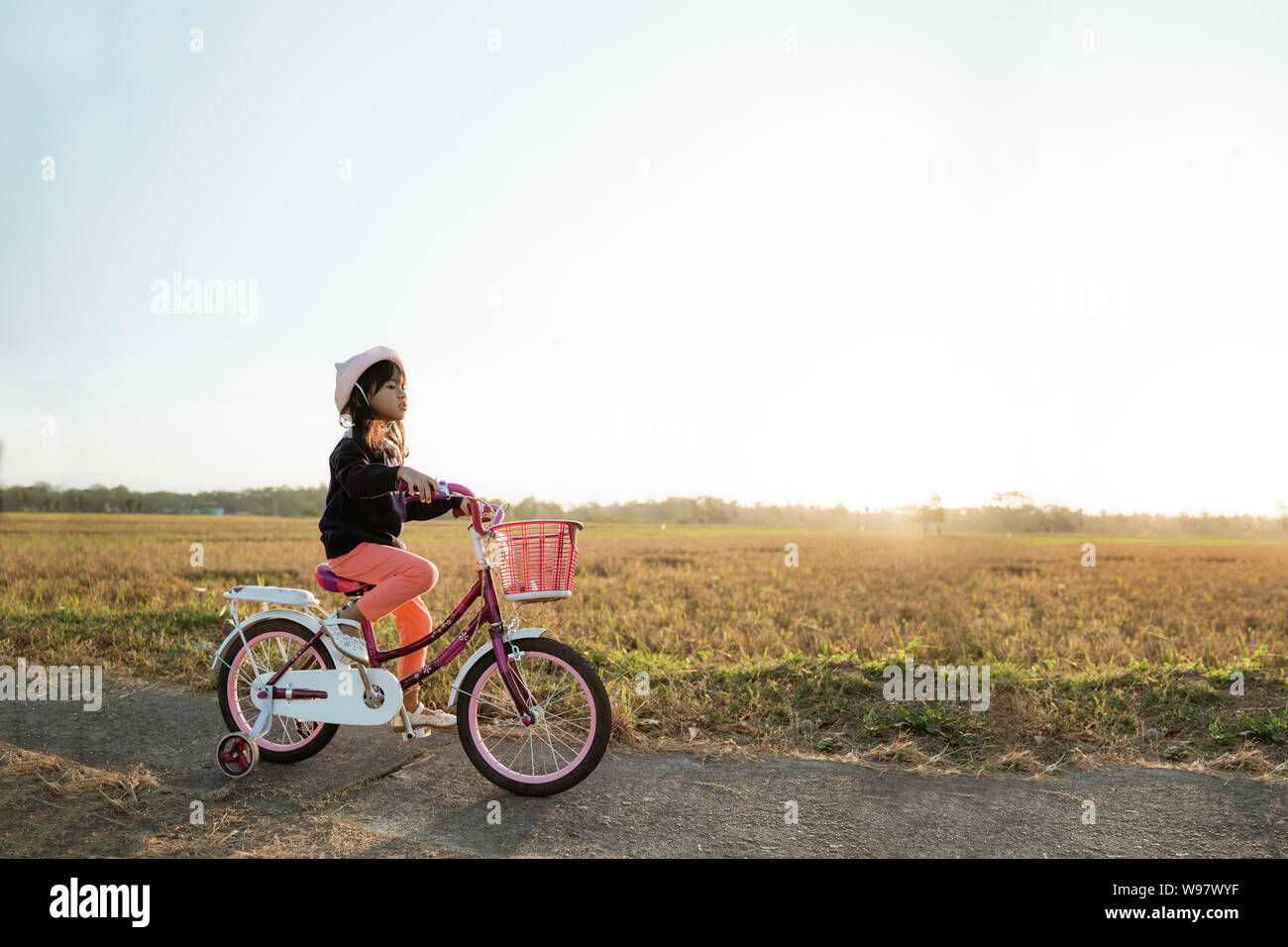 independent asian child ride her bicycle Stock Photo - Alamy