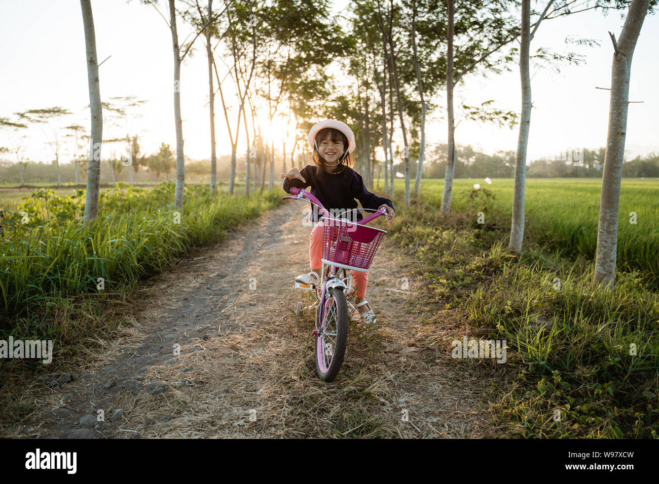 independent asian child ride her bicycle Stock Photo - Alamy