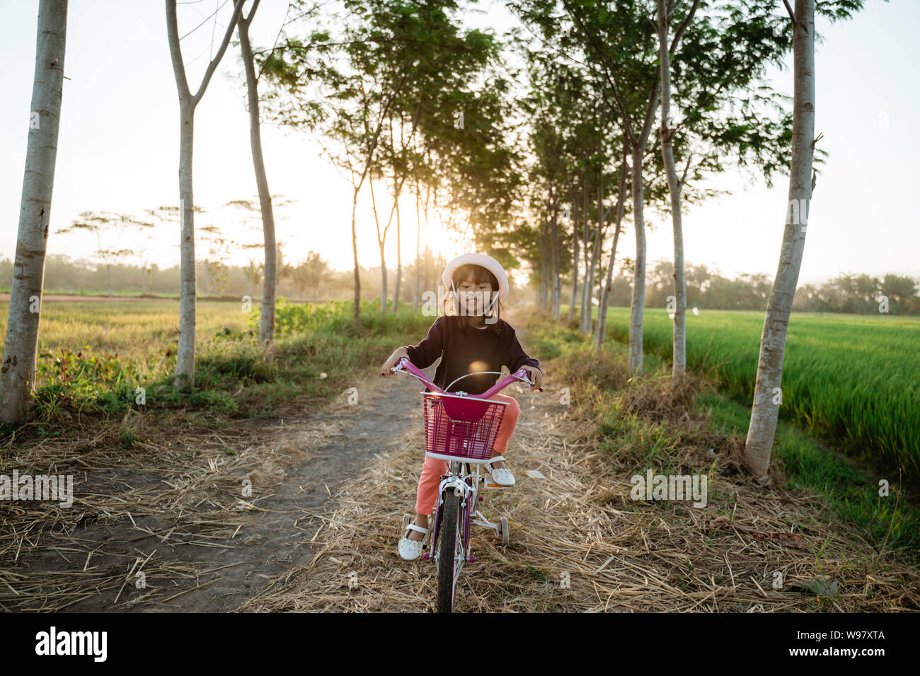 independent asian child ride her bicycle Stock Photo - Alamy