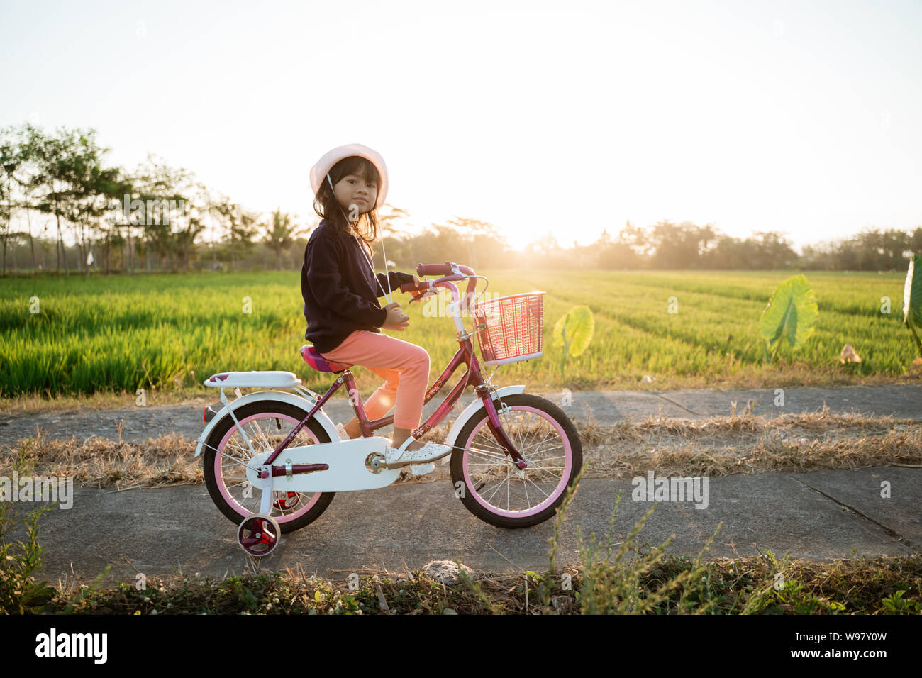 independent asian child ride her bicycle Stock Photo - Alamy