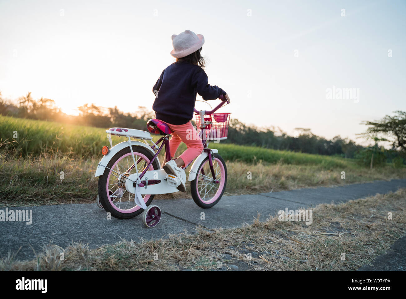 back view of a child riding a bicycle Stock Photo - Alamy