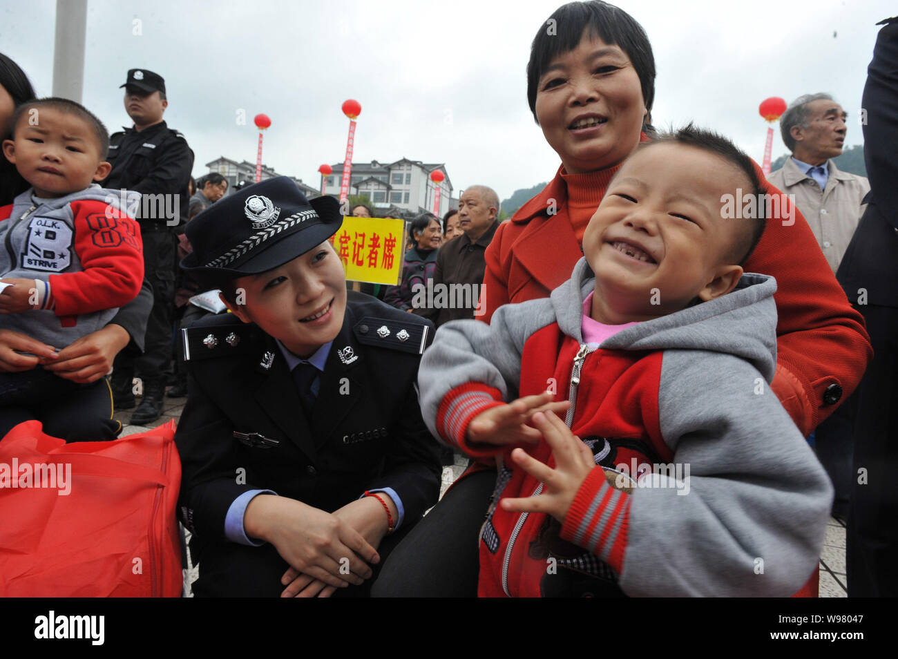 A child smiles after being reunited with his family in Zunyi, southwest ...