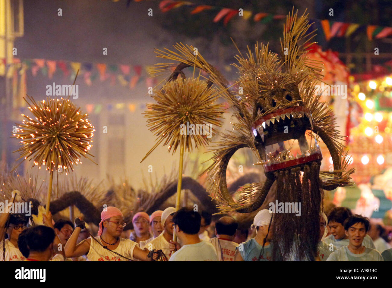 Local residents perform the Fire Dragon Dance to celebrate the Mid ...