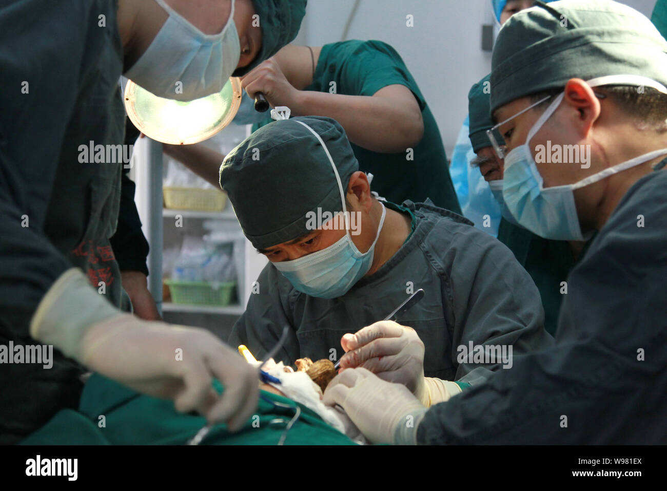 Doctors are seen busy with operating on the woman at Beijing Military ...