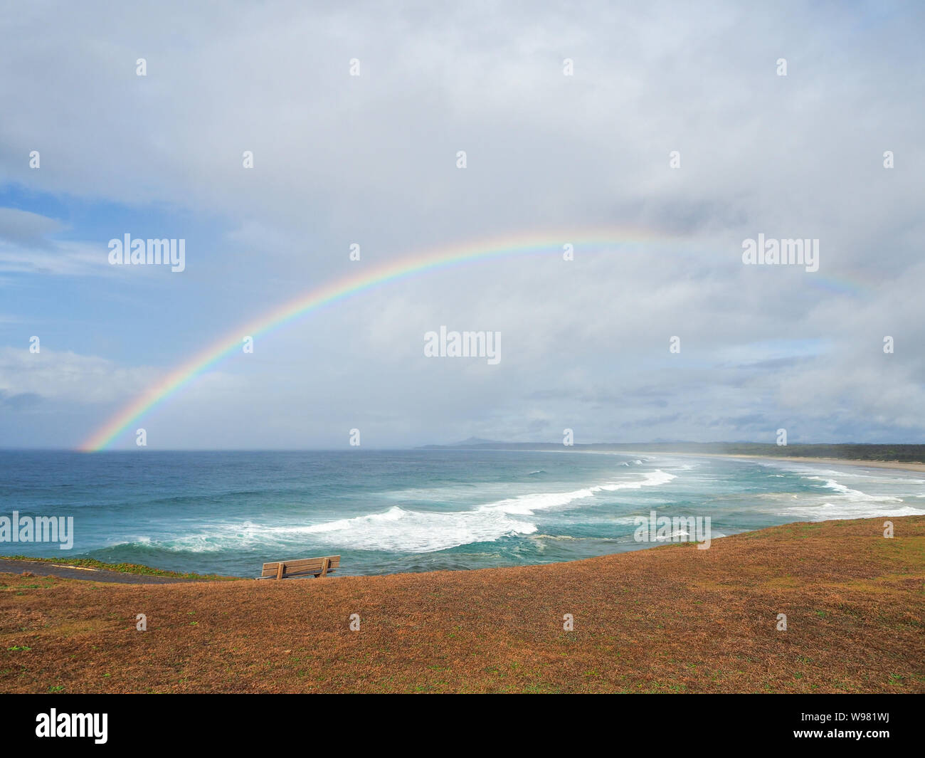 Nature, what a stunner! A beautiful Rainbow arch at the beach, waves ...