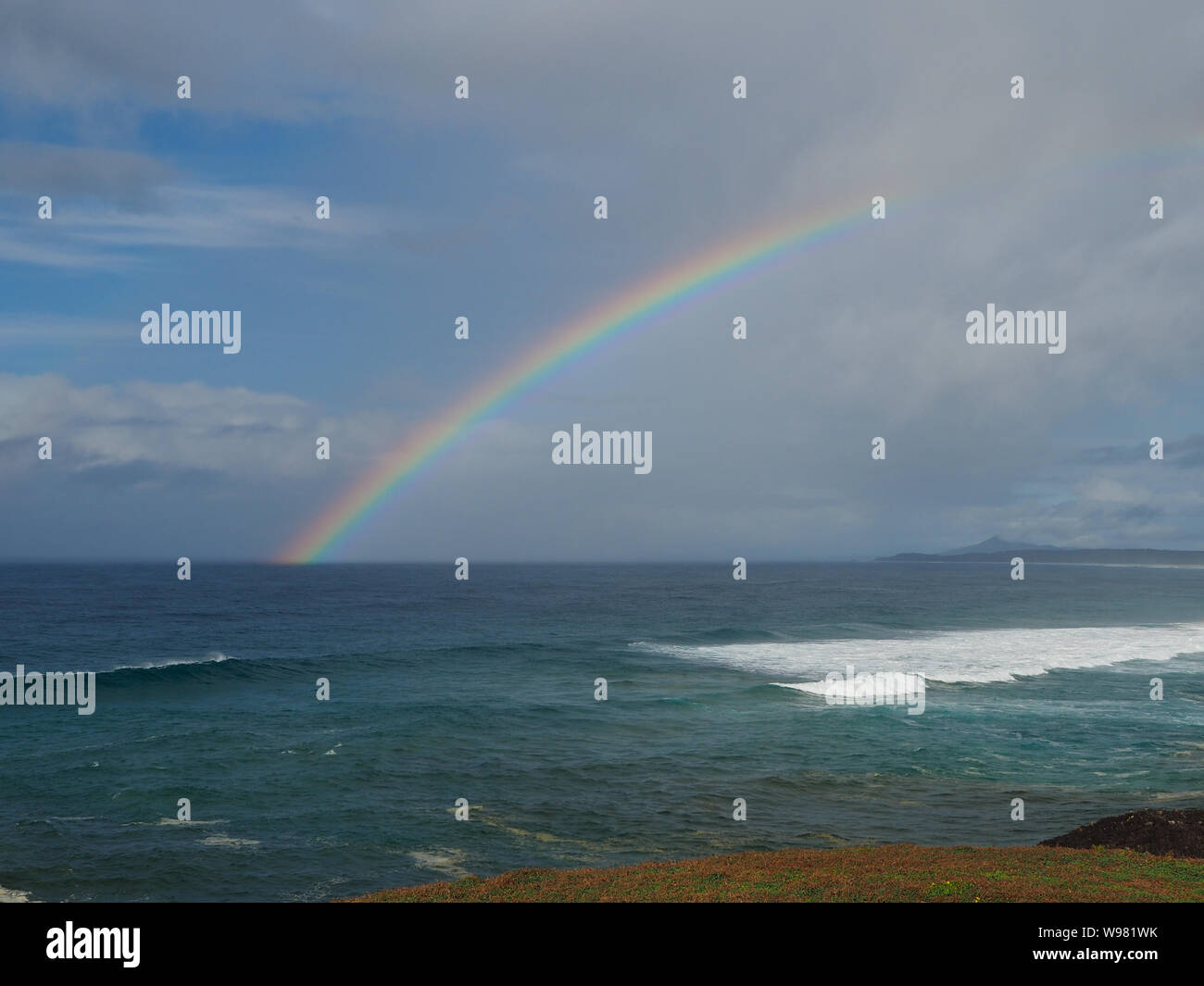 Rainbow over the ocean Stock Photo - Alamy