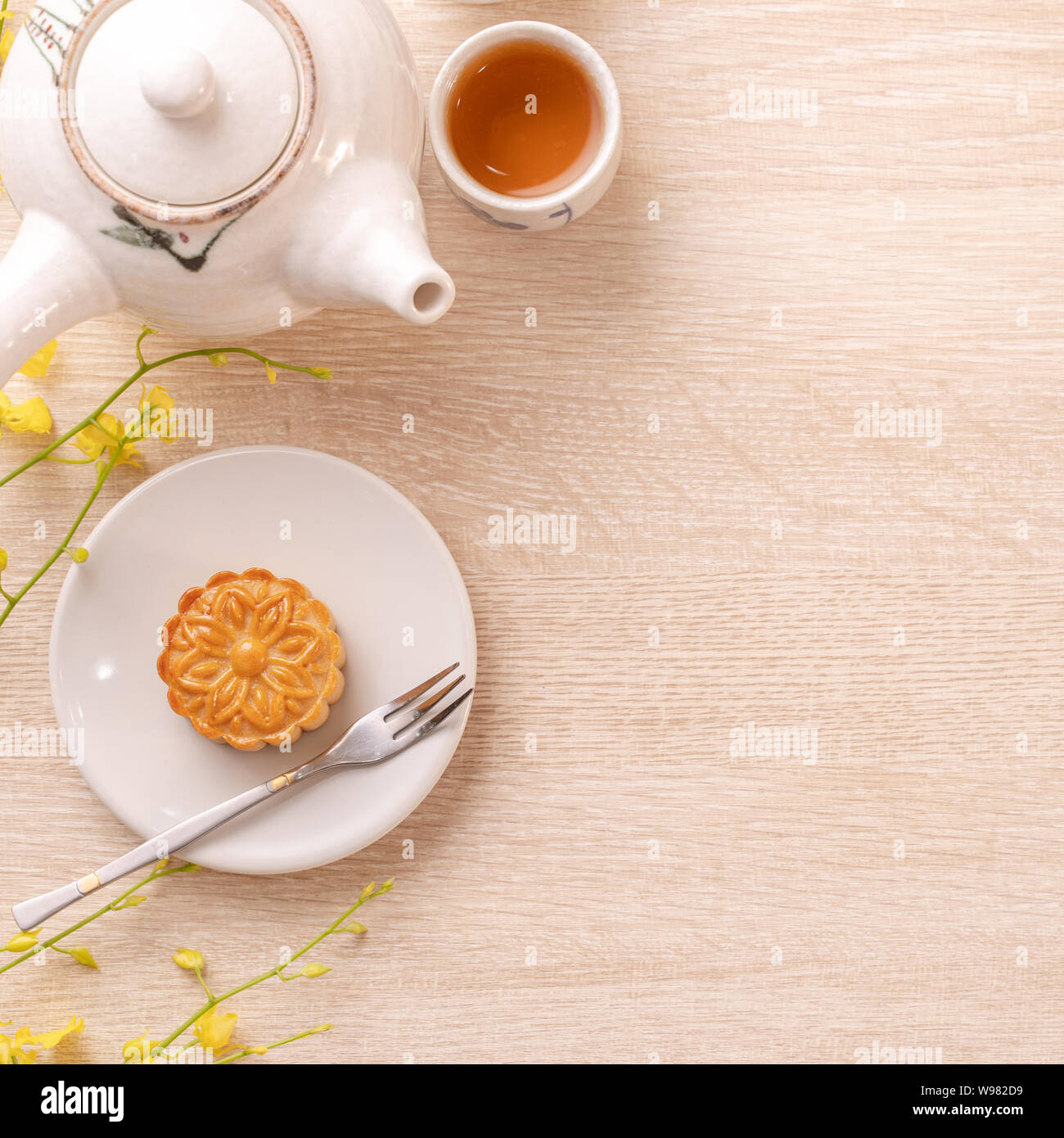Tasty moon cake for Mid-Autumn festival on bright wooden table, concept ...