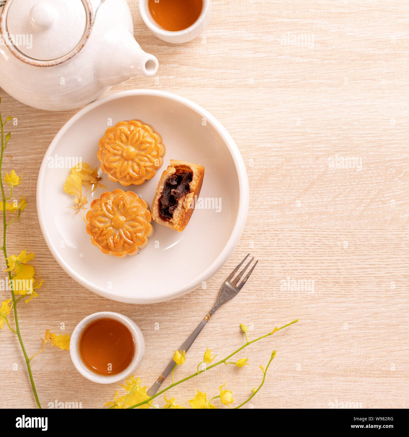 Tasty moon cake for Mid-Autumn festival on bright wooden table, concept ...