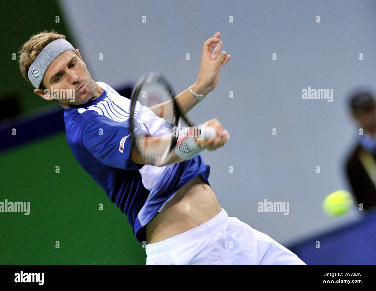 Mardy Fish of the United States returns a shot against Bernard Tomic of ...