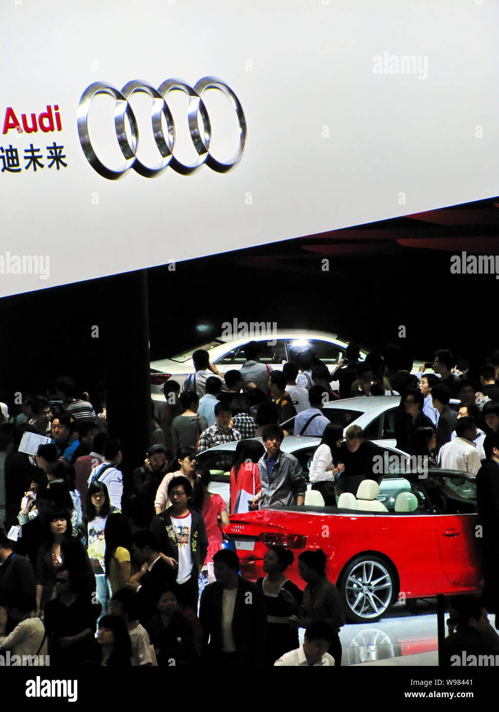 --File--People crowd a stand of Audi, Volkswagens premium car brand, at ...