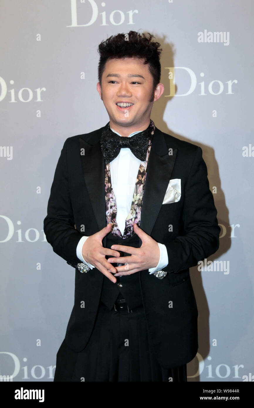 Chinese stylist Tony Li (Li Dongtian) poses at the opening ceremony of ...