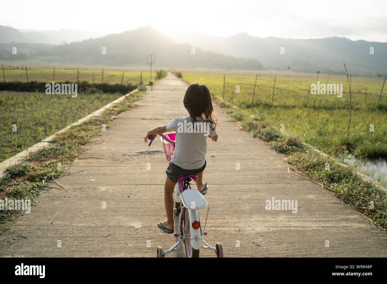 independent asian child ride her bicycle Stock Photo - Alamy