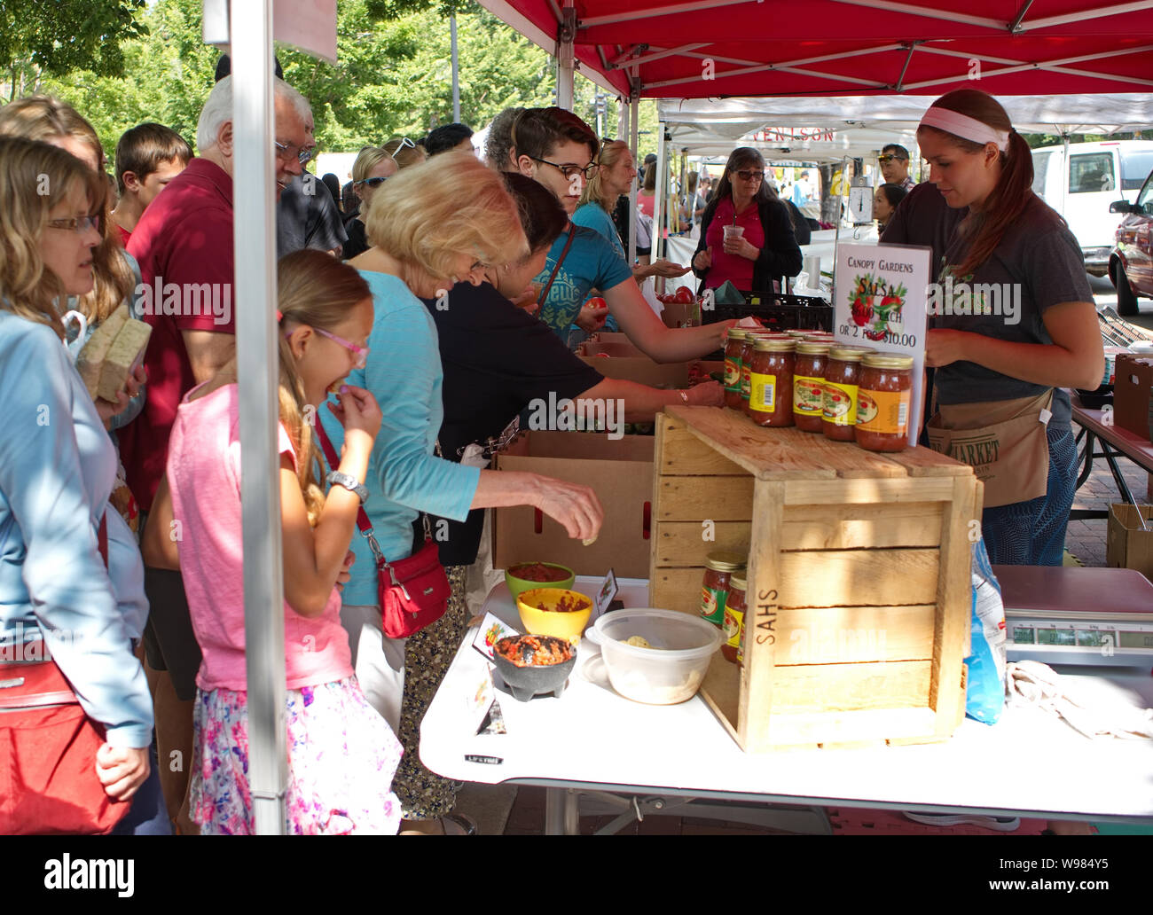 Farmers Market, Madison, WI USA. Aug 2018. A focused young woman in ...