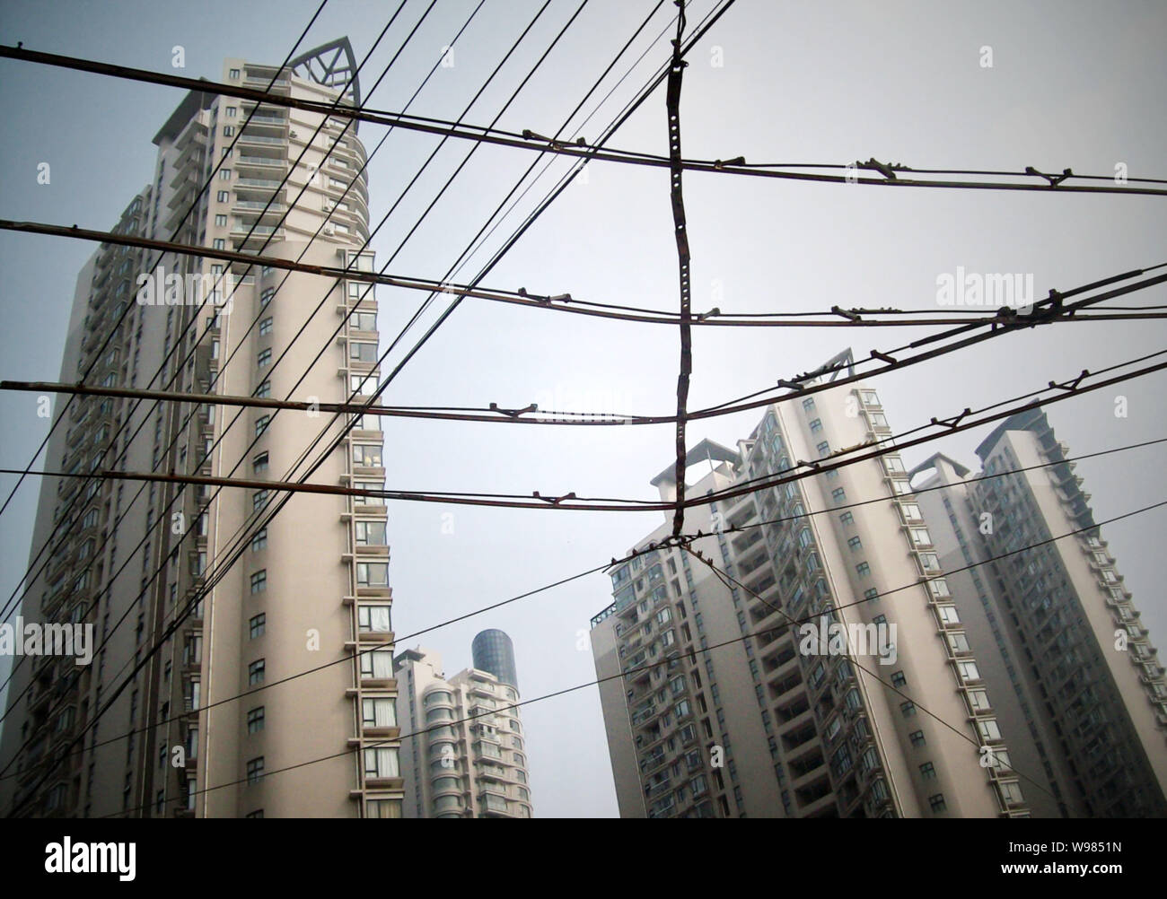 --FILE--Residential apartment buildings are pictured through electrical ...