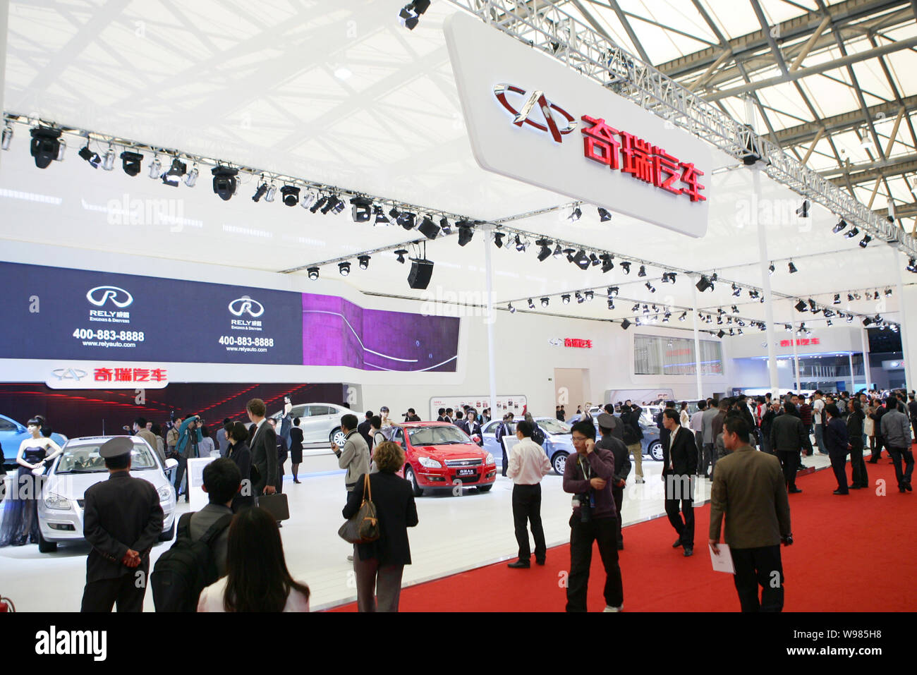 --FILE--Visitors look at cars displayed at the booth of Chery during ...