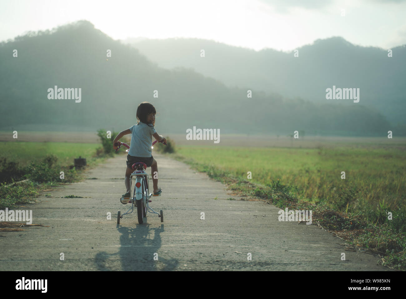 independent asian child ride her bicycle Stock Photo - Alamy