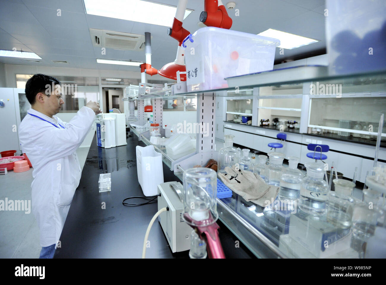 A Chinese worker tests additives contained in sample food in the lab of ...