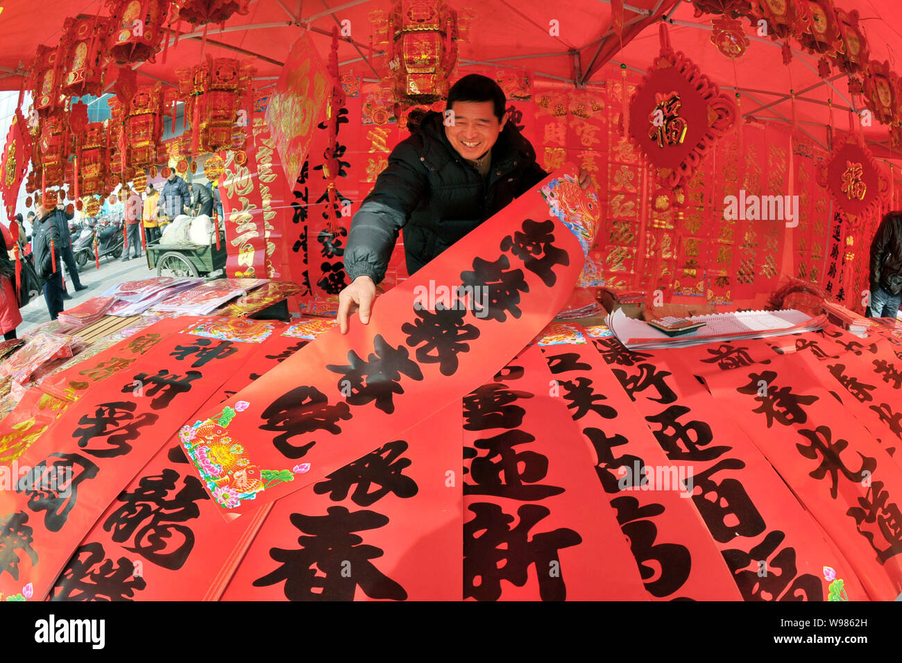 A Chinese vendor sells red lanterns and Spring Festival scrolls in ...