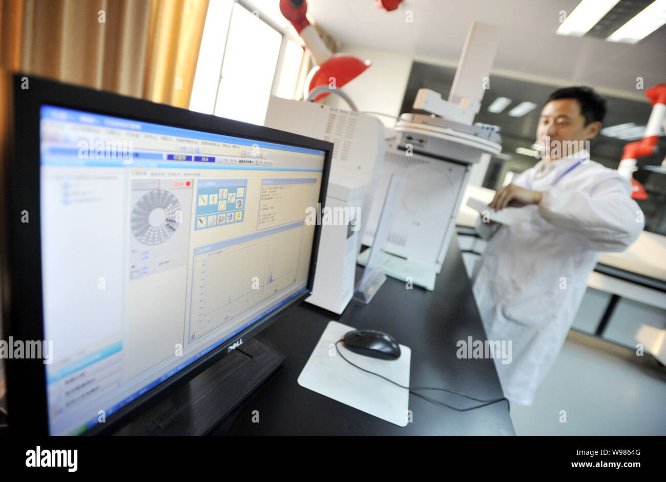 A Chinese worker tests additives contained in sample food in the lab of ...