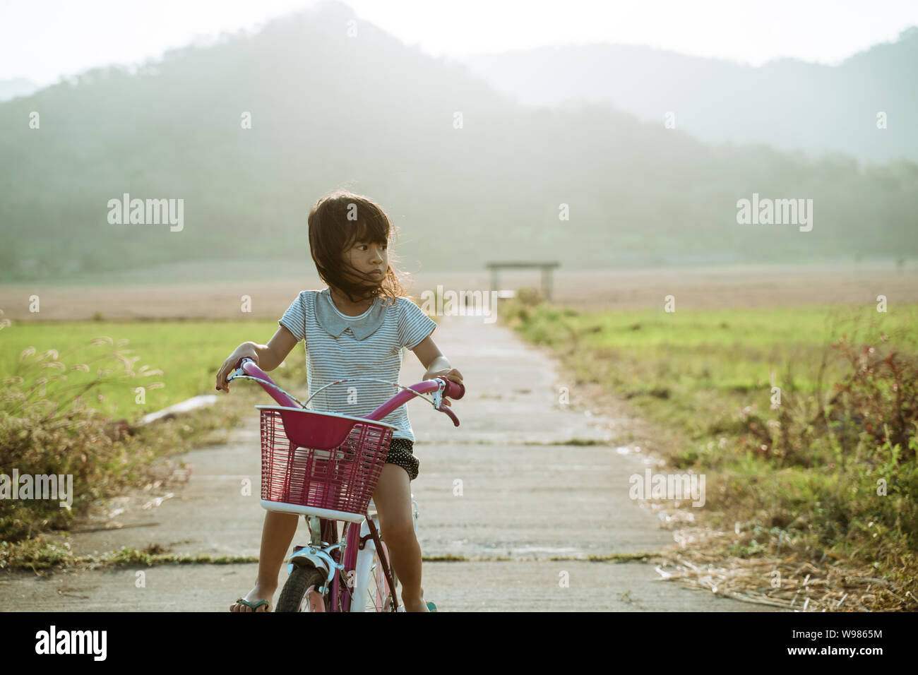 independent asian child ride her bicycle Stock Photo - Alamy