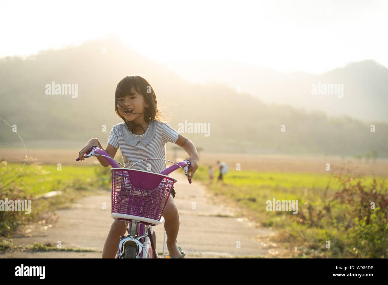 independent asian child ride her bicycle Stock Photo - Alamy