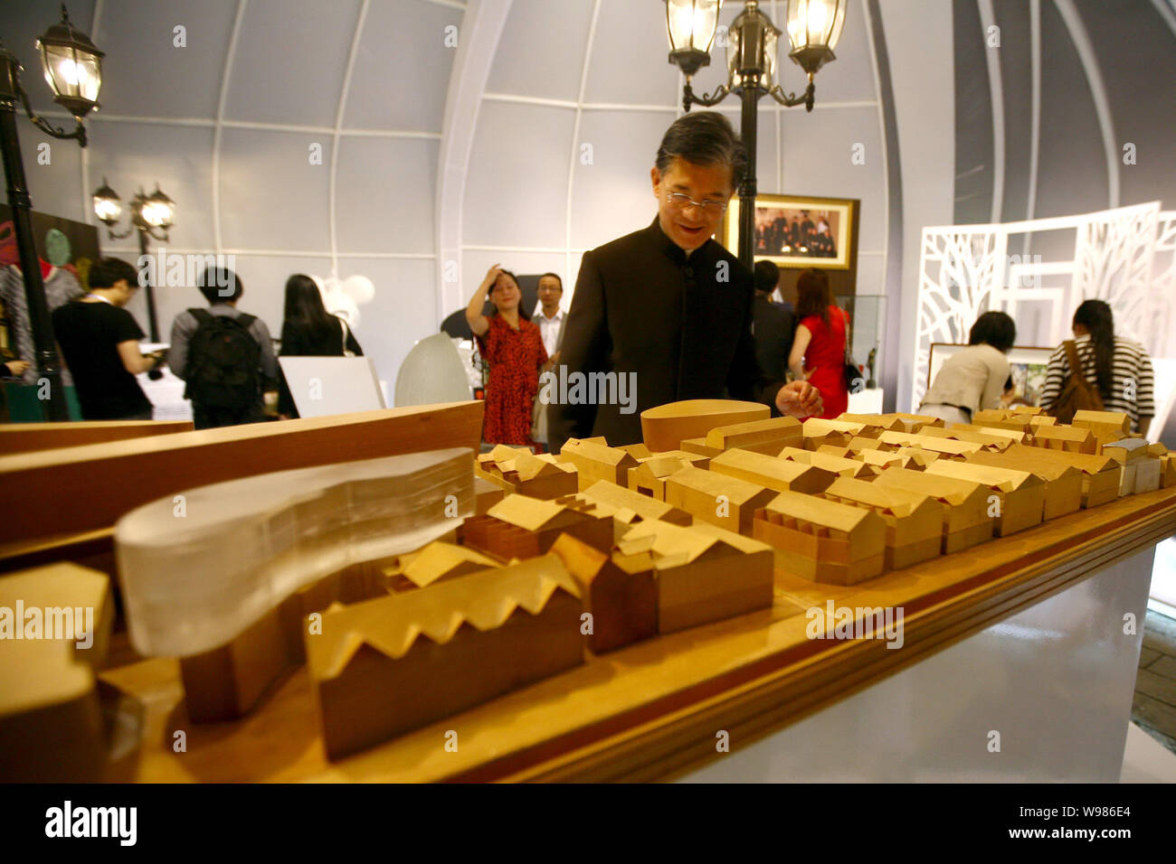 Vincent Lo, Chairman of Shui On Group, looks at a model of Xintiandi, a ...