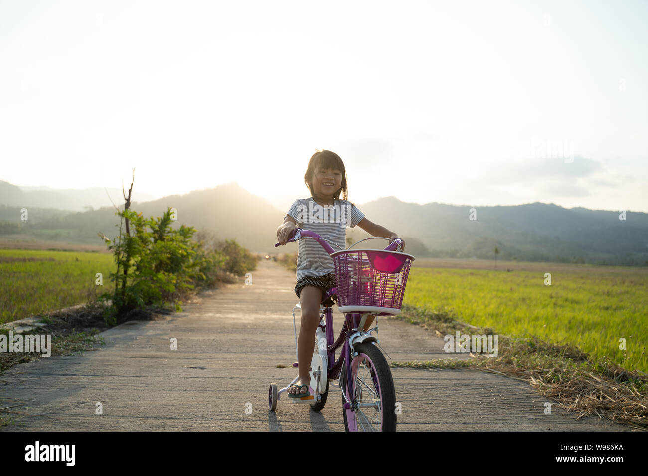 independent asian child ride her bicycle Stock Photo - Alamy