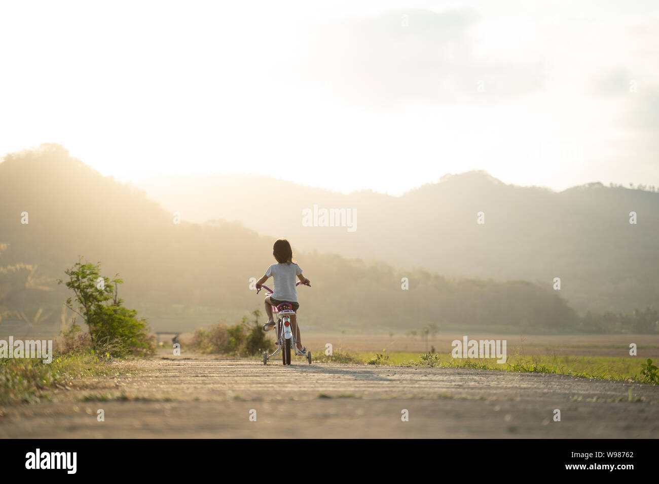 independent asian child ride her bicycle Stock Photo - Alamy