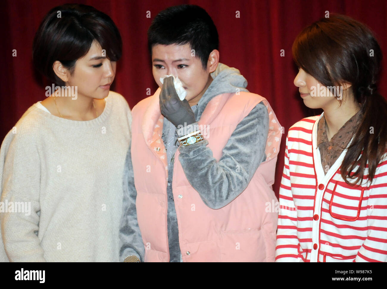 Selina Jen (or Selina Ren), center, weeps next to Ella Chen, left, and ...